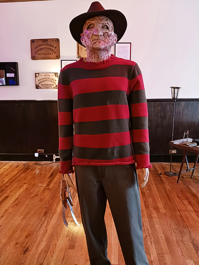 Life-sized figures of horror icons like Freddy Krueger stand in shadowy corners, their familiar silhouettes triggering childhood nightmares.