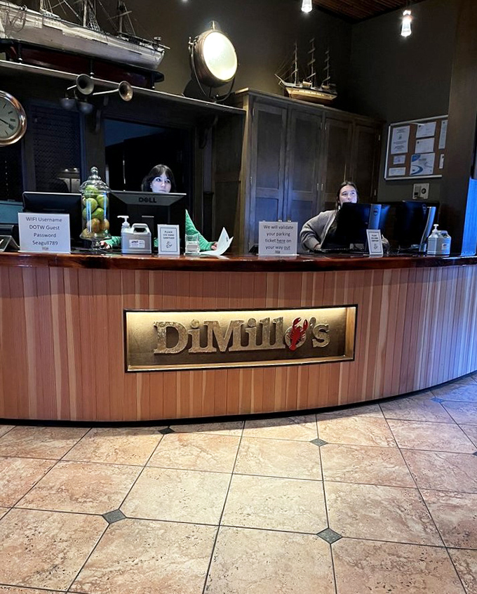 The welcoming front desk greets visitors with maritime charm, setting the stage for the culinary voyage that awaits aboard this floating restaurant.