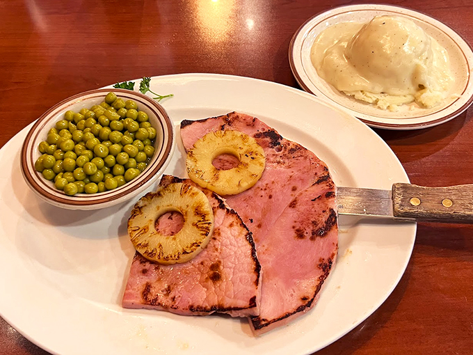 Meat lovers, rejoice! This ham steak is a carnivore's dream come true, served with a side of nostalgia.