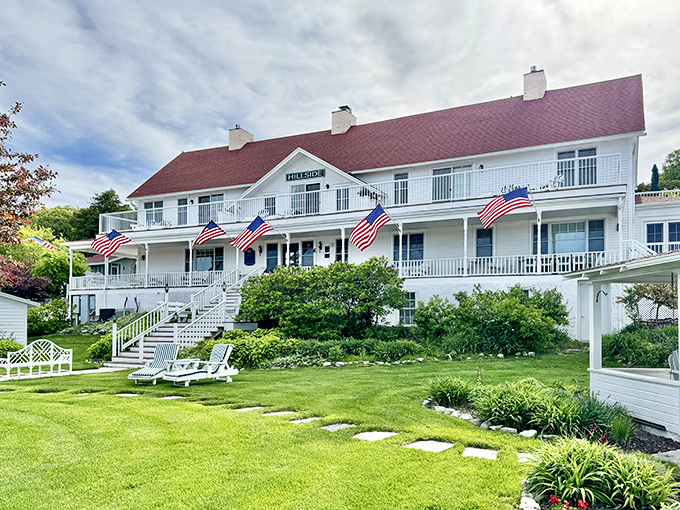 The Hillside Inn's grand white presence, adorned with American flags, offers harbor views that guests remember for decades.