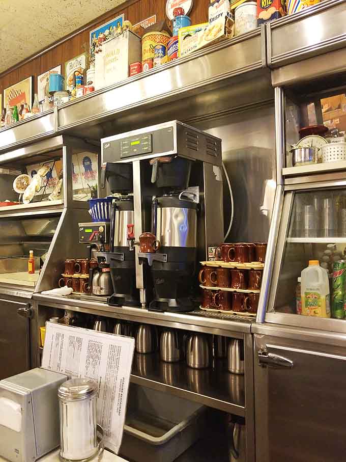 Behind the counter, the coffee station stands ready with those iconic brown mugs, the true heroes of any proper diner.