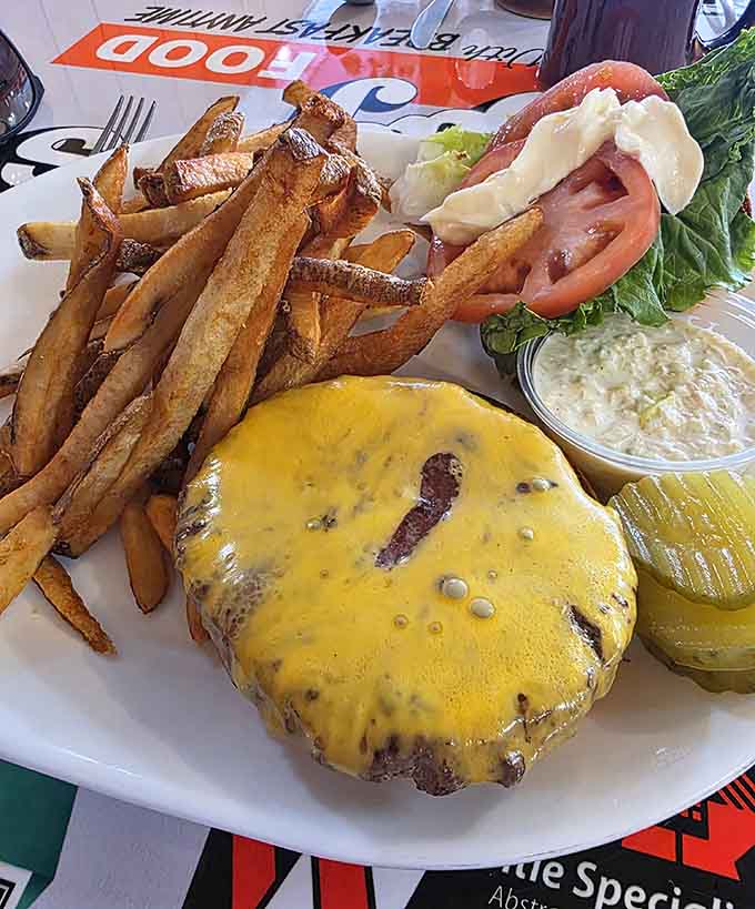 This cheeseburger means serious business, topped with melted cheese and served with fries that'll make you forget every diet you've ever attempted.