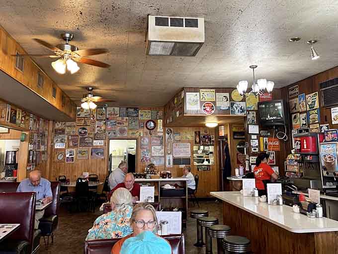 Vintage signs and memorabilia covering every available surface, turning breakfast into a trip through Americana without leaving your booth.
