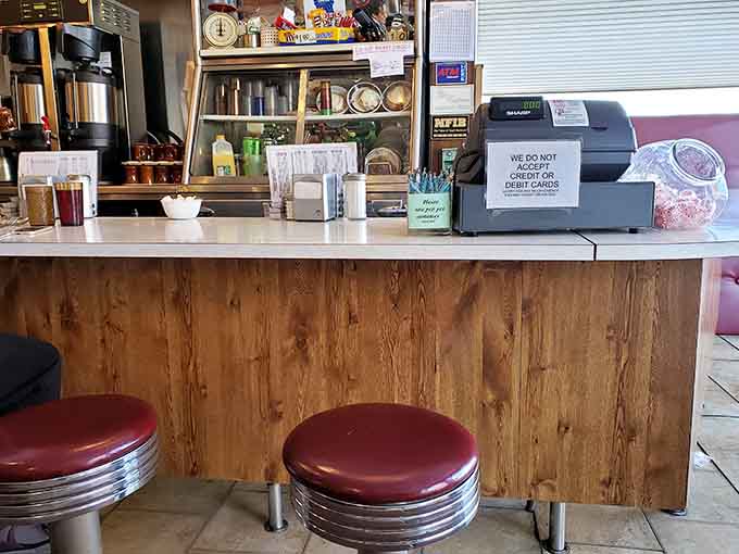 The counter where coffee flows freely and servers know your order before you finish saying good morning.