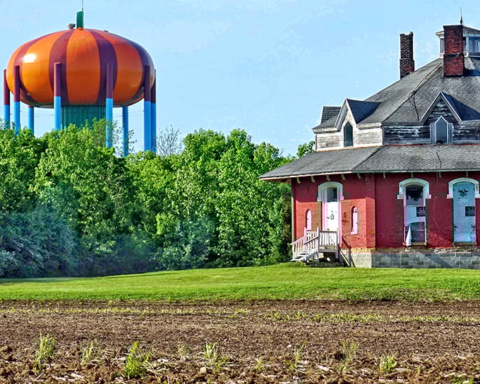 Local homes seem to huddle beneath the watchful eye of their pumpkin overlord, creating a scene both comical and oddly comforting.