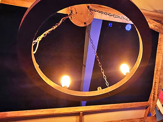 Rustic lighting creates an atmosphere where shadows become characters and every creak might be something following you.