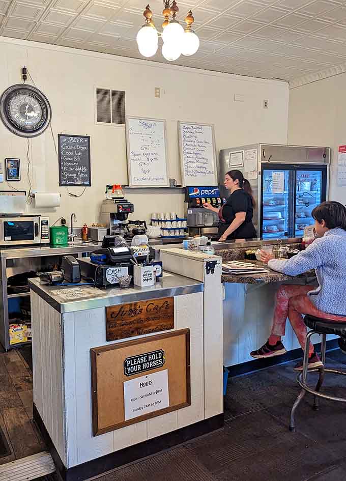 The counter seating offers front-row views of the kitchen action, where you can watch your breakfast being prepared by people who actually know what they're doing.
