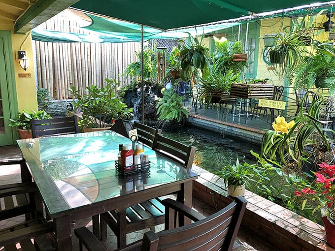 This tranquil garden oasis offers the ideal setting for serious dessert contemplation, surrounded by tropical plants and gentle water features.