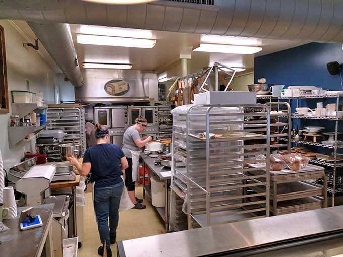 The kitchen hums with purposeful energy as bakers transform simple ingredients into edible art with practiced, flour-dusted hands.