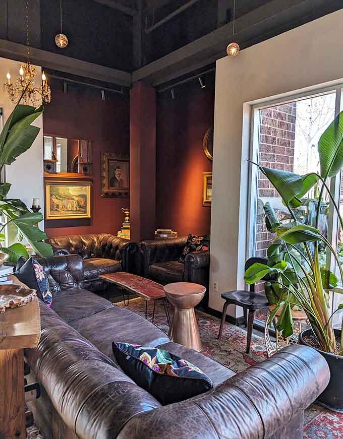 Oversized leather sofas and vintage coffee tables create a lounge vibe that encourages lingering long after your plate is empty.