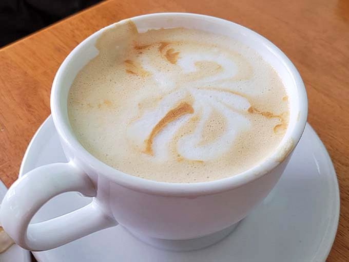 Latte art so pretty you almost don't want to drink it. Almost. That creamy swirl is calling your name.