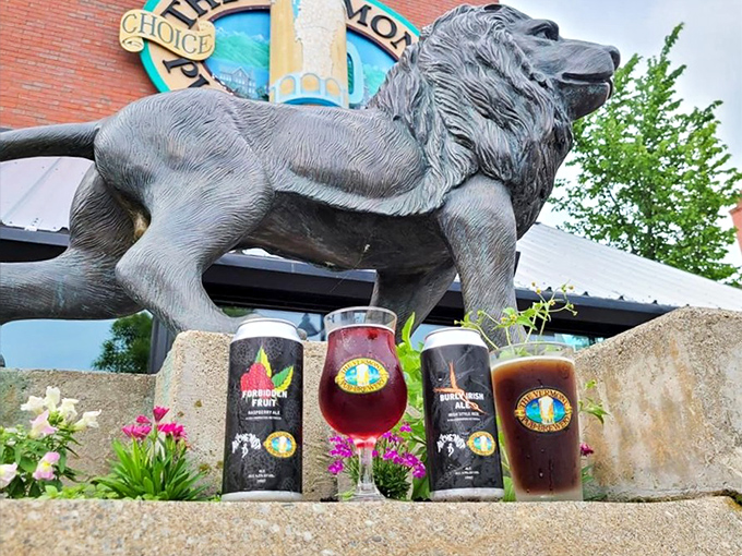 The brewery's iconic lion sculpture stands guard over specialty brews, including their famous fruit-forward offerings in distinctive glassware.