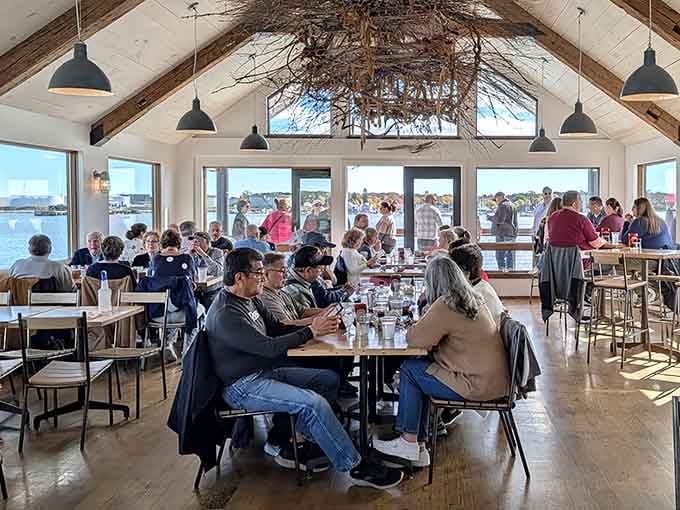 Happy diners enjoying fresh catches with panoramic water views, this is the Maine experience everyone talks about back home.