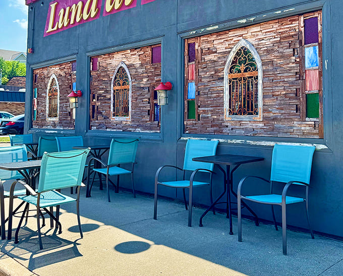 Turquoise chairs on the patio offer front-row seats to Bloomington street life, perfect for warm evenings when dining al fresco sounds just right.