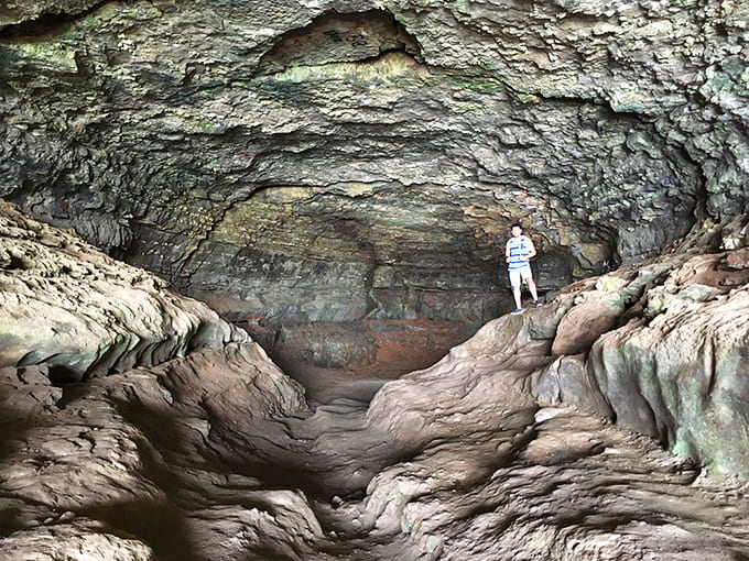 The cave's interior provides enough space to stand comfortably while contemplating the river pirates who once called this home.