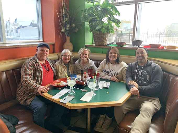 Happy diners gathered around a table prove that good food and good company create the kind of magic no algorithm can replicate.