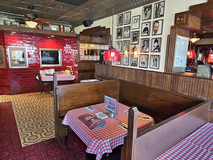 Wooden booths and checkered tablecloths create cozy spaces where families have been making memories for generations.