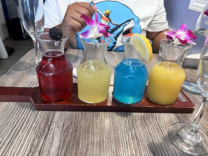 A mimosa flight that's practically begging for your Instagram &ndash; four vibrant juices from classic orange to electric blue, each topped with a delicate orchid.