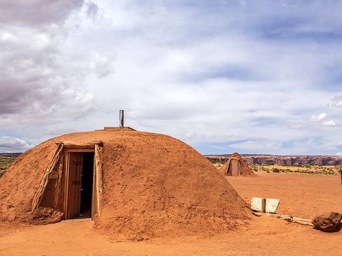 Traditional hogans dot the landscape, eight-sided homes that have sheltered Navajo families through countless desert seasons and stories.