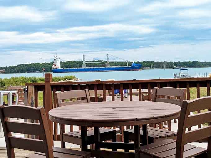 The outdoor deck offers front-row seats to nature's greatest show – massive freighters gliding by as you savor every delicious bite.