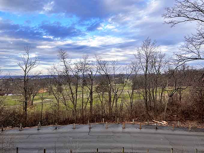 Rolling hills unfold beneath a cloud-dappled sky, showcasing Ohio's understated beauty that too often goes unappreciated by hurried travelers.