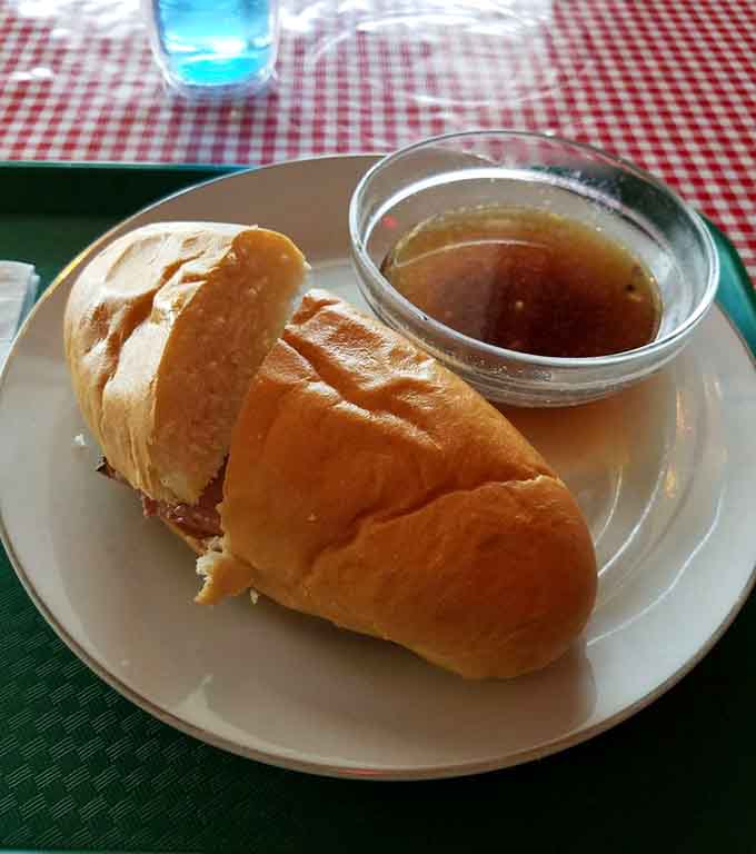 A French dip sandwich ready for its au jus bath, the kind of lunch that makes afternoon meetings bearable.