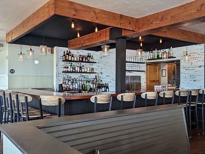 The bar area combines sleek design with comfortable seating, perfect for cocktails while you wait or just because.