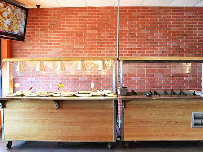 The buffet station keeps pizzas rotating faster than a DJ's turntable, ensuring every slice you grab is hot and fresh from the oven.