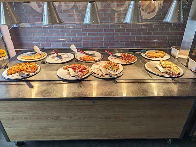 Fresh pizzas line up like edible soldiers, each slice a different adventure waiting to happen on your plate.
