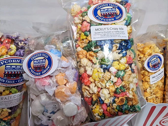 Vibrant rainbow kernels peek through branded packaging, each bag a portable party waiting to happen.