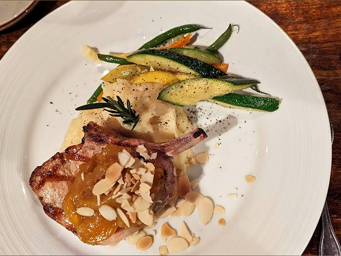 A juicy porkchop glistening with glaze and topped with almonds &ndash; proof that pigs didn't just give us bacon, they gave us art.