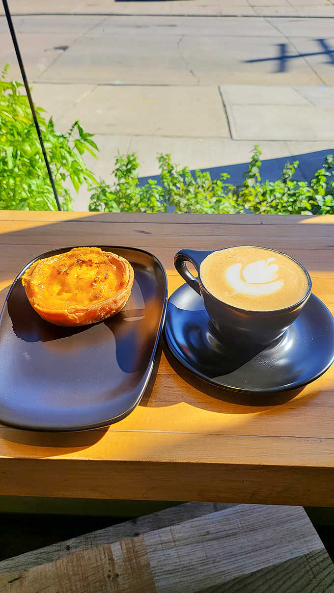 A study in contrasts: a savory quiche with herbs alongside a sweet pastry with pink icing, proving 5 Points masters both sides of the flavor spectrum.