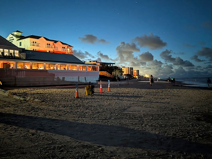 As day turns to dusk, The Breakers transforms into a glowing beacon of hospitality against the darkening beach sky.