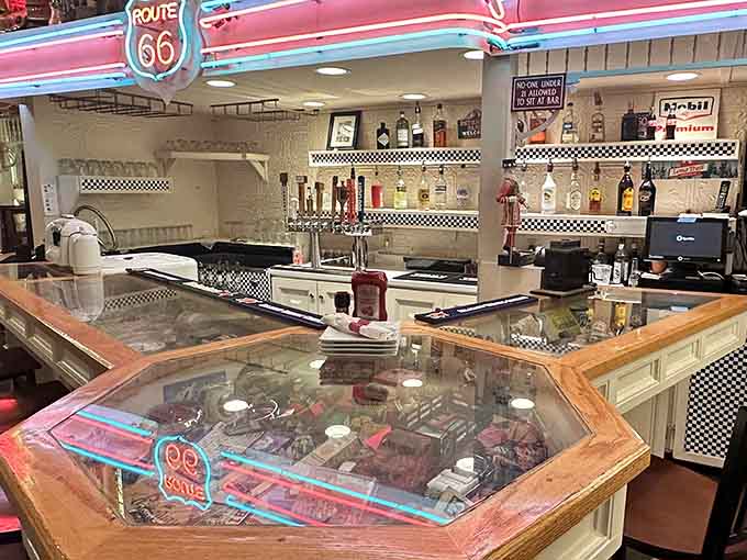The bar area gleams with chrome and checkered patterns, ready to serve cold drinks in an atmosphere that's pure 1950s cool.