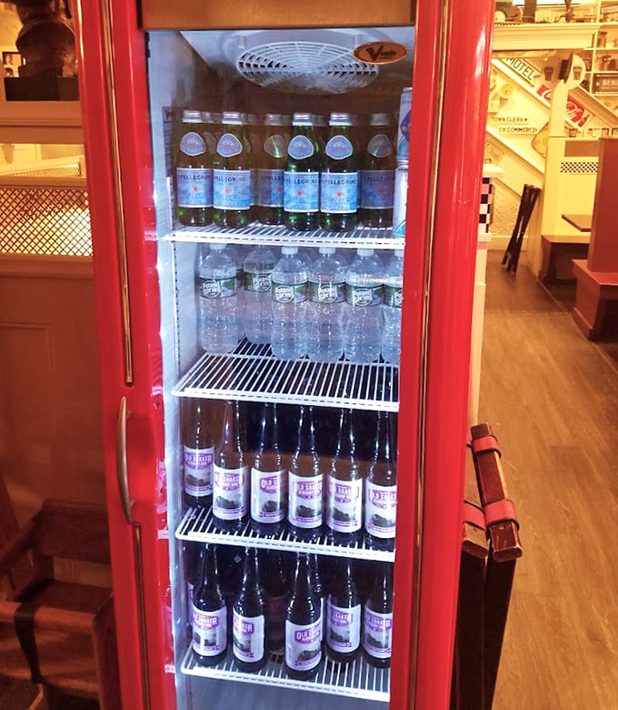 Vintage-style refrigerators stocked with local beverages prove that nostalgia and supporting local businesses can coexist beautifully.