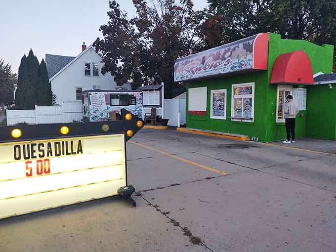 That vertical "TACOS" sign stands tall like a delicious lighthouse, guiding hungry souls safely to shore since day one.