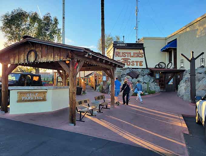 The entrance pathway with desert landscaping sets the stage for your Wild West dining adventure ahead.