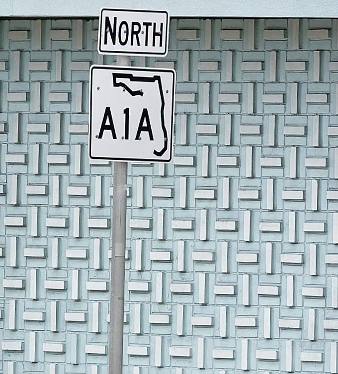 St. Augustine's A1A signage stands against vintage architecture, blending modern road-tripping with America's oldest city's timeless charm.