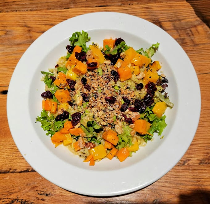 A rainbow of butternut squash, dried cranberries, and fresh greens proves that salads don't have to be boring to be virtuous.