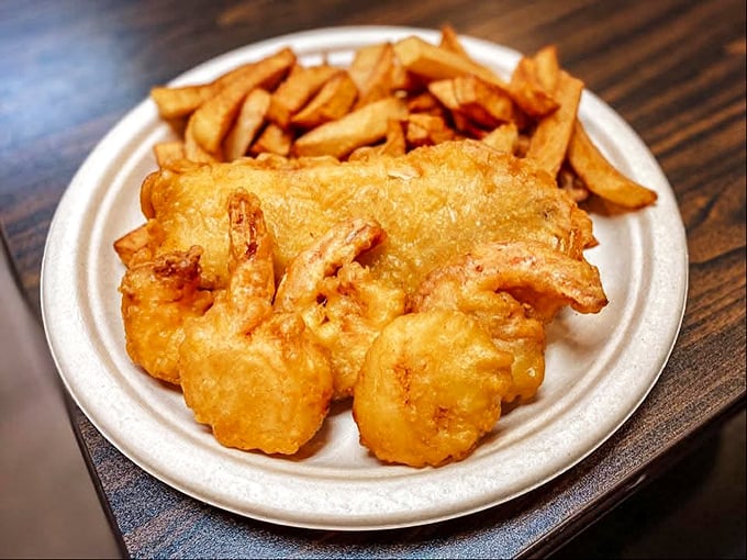 The seafood combo plate offers an oceanic trinity of treasures &ndash; fish, shrimp, and scallops united under a crispy batter banner.