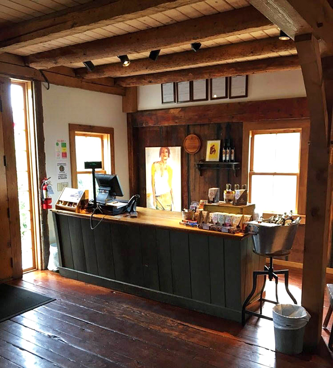 The welcoming service counter, framed by warm wooden beams, serves as the friendly gateway to Vermont's most delicious liquid treasures.