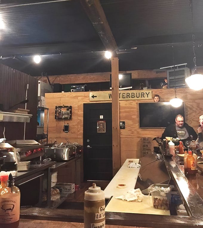 Behind the rustic wooden counter, culinary magic happens with practiced precision &ndash; the open kitchen concept adding theatrical elements to an already sensory-rich dining experience.