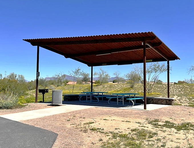 The shaded picnic shelter provides desert refuge for snack breaks and birthday celebrations &ndash; because even playground adventurers need refueling stations.