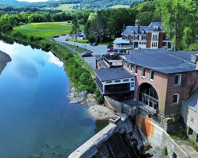 Historic mill buildings along the Ottauquechee River – where human ingenuity harnessed nature's power long before electricity was cool.