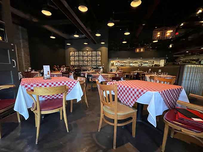 Red and white checkered tablecloths add a playful touch to the industrial space, creating the perfect backdrop for serious seafood eating.