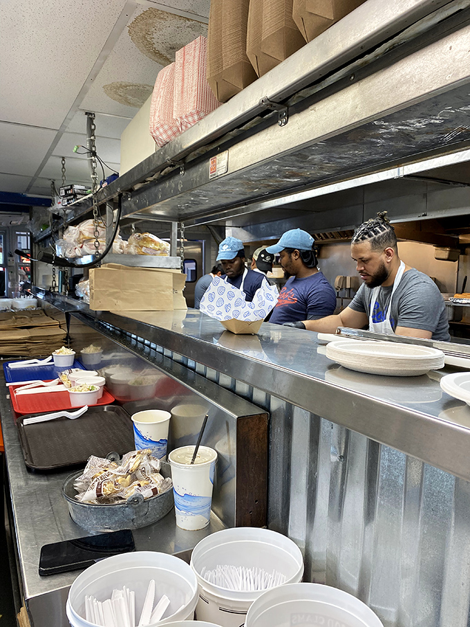 The dedicated kitchen staff works with practiced precision, transforming fresh seafood into golden, crispy masterpieces that keep customers coming back.