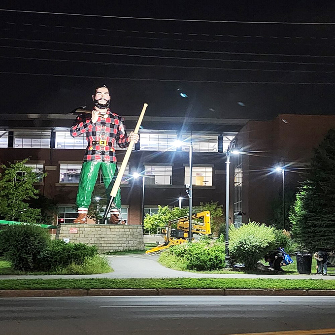Even at night, Paul Bunyan stands watch over Bangor, illuminated dramatically against the darkness like a guardian of the city's logging heritage.