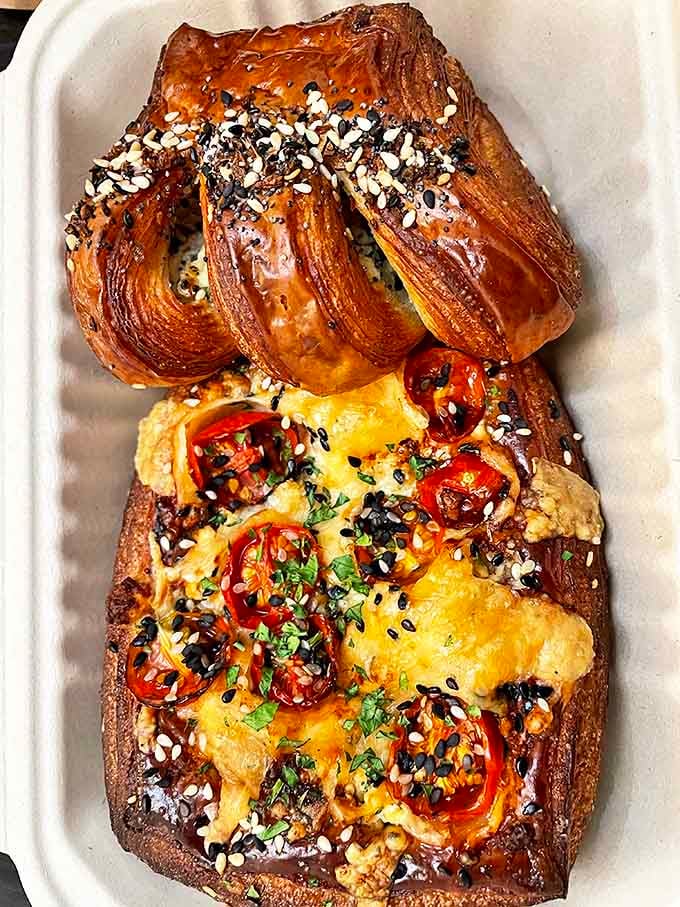Savory meets sweet in this artistic arrangement &ndash; roasted tomatoes and cheese nestled in golden croissant dough alongside an everything bagel creation.