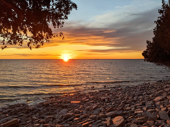 The sun sets over Lake Michigan at Fayette, painting the sky in colors that 19th-century iron workers would have admired after long shifts.