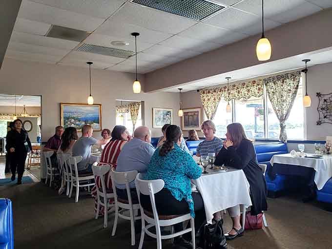 Groups gather around white-clothed tables for celebrations and special occasions, creating memories over exceptional European cuisine.
